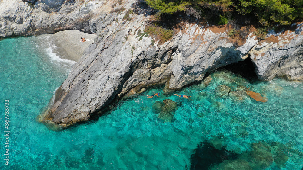 Aerial drone photo of secluded rocky cove near turquoise pebble ...