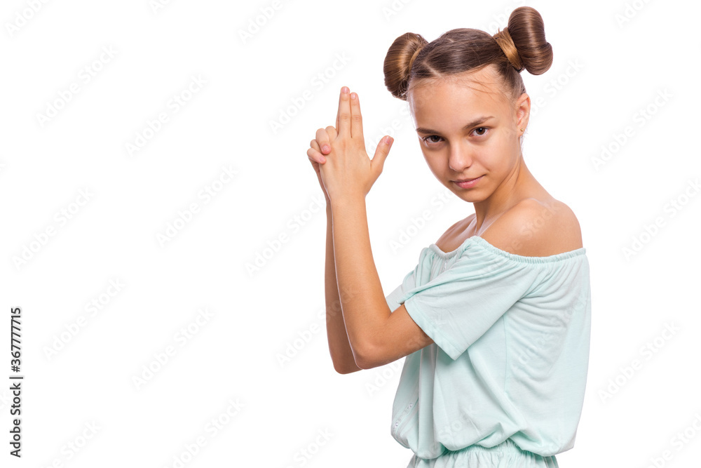 Portrait of funny teen girl doing gun gesture getting ready to shoot ...