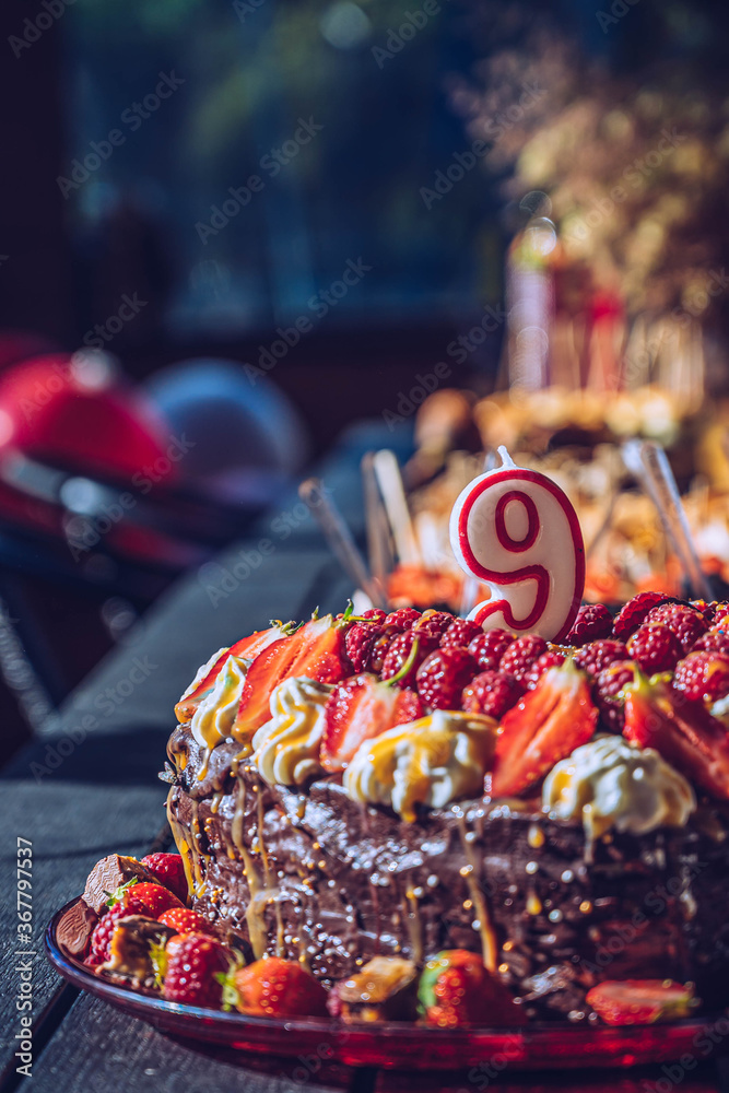 Chocolate birthday cake with candle. 9th birthday cake. Stock Photo ...