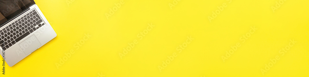 Keyboard laptop computer isolated on yellow desk background. Modern ...