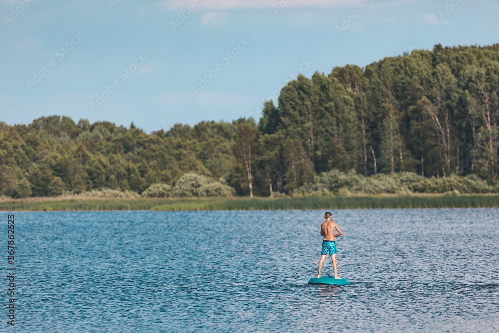 Boys on rafts swim on water Stock Photo | Adobe Stock