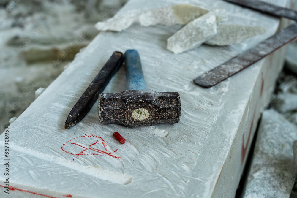 Sculptor tools on a marble slab, close up. Workplace, traditional tools ...