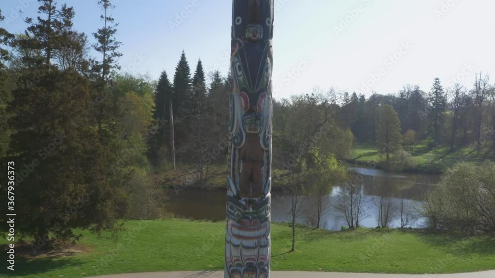 HD shot of tribal native american totem pole with face sculptures in ...