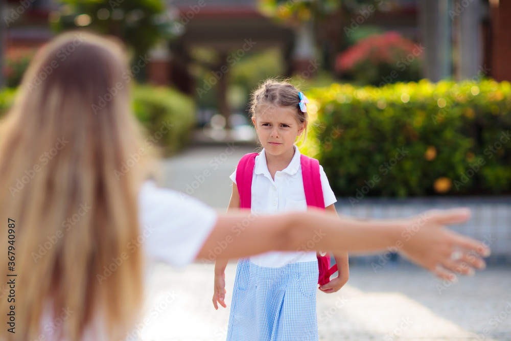 School pick up. Mother and kids after school. Stock Photo | Adobe Stock
