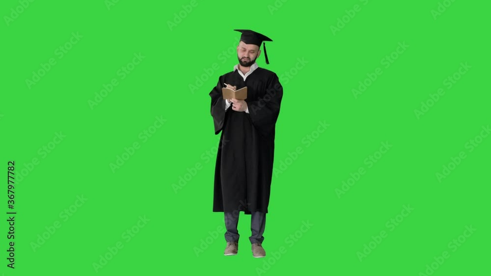 Graduation man writing his thoughts on a Green Screen, Chroma Key ...