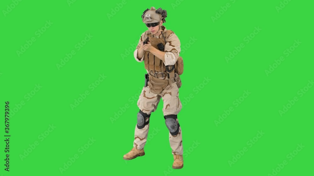 American soldier with pistol aiming and shooting on a Green Screen ...
