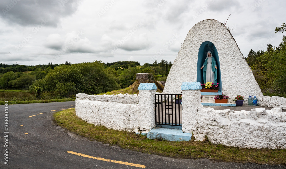 Old roadside shrine of the Virgin Mary in rural Ireland at sunrise ...