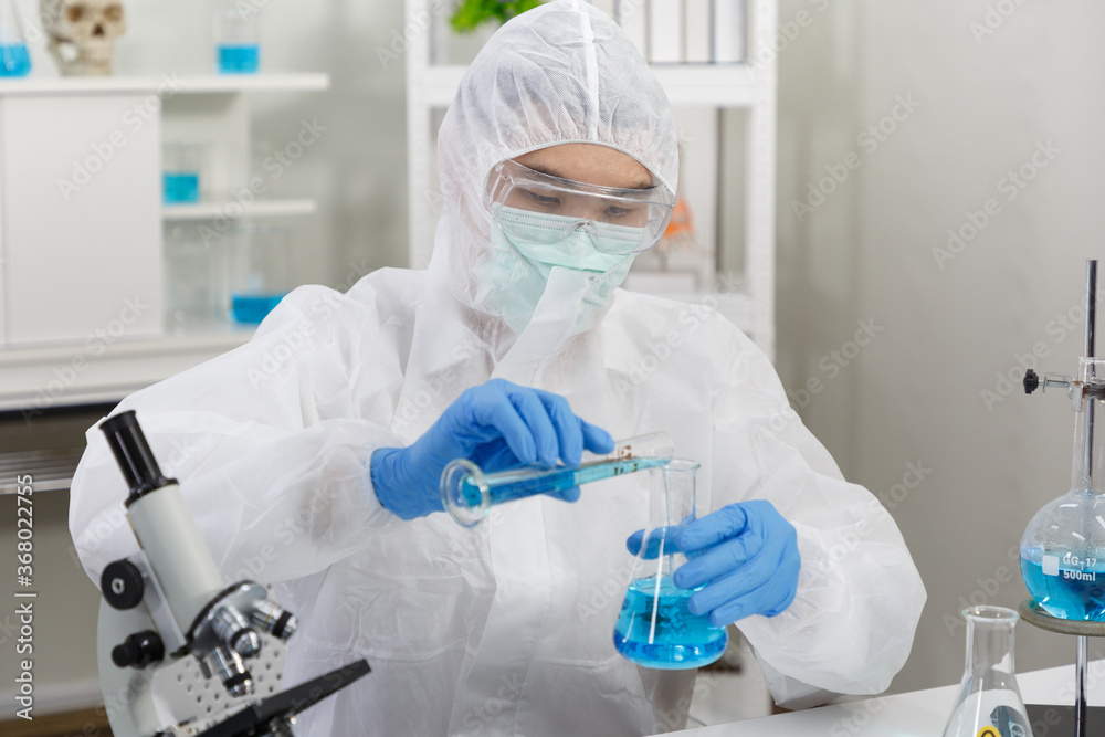 Male Scientist in PPE Suit working in Lab while Pouring Solution from ...