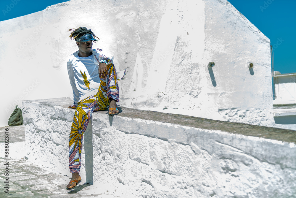 Italian immigrant man of sub-Saharan origin with sun hat and black and ...