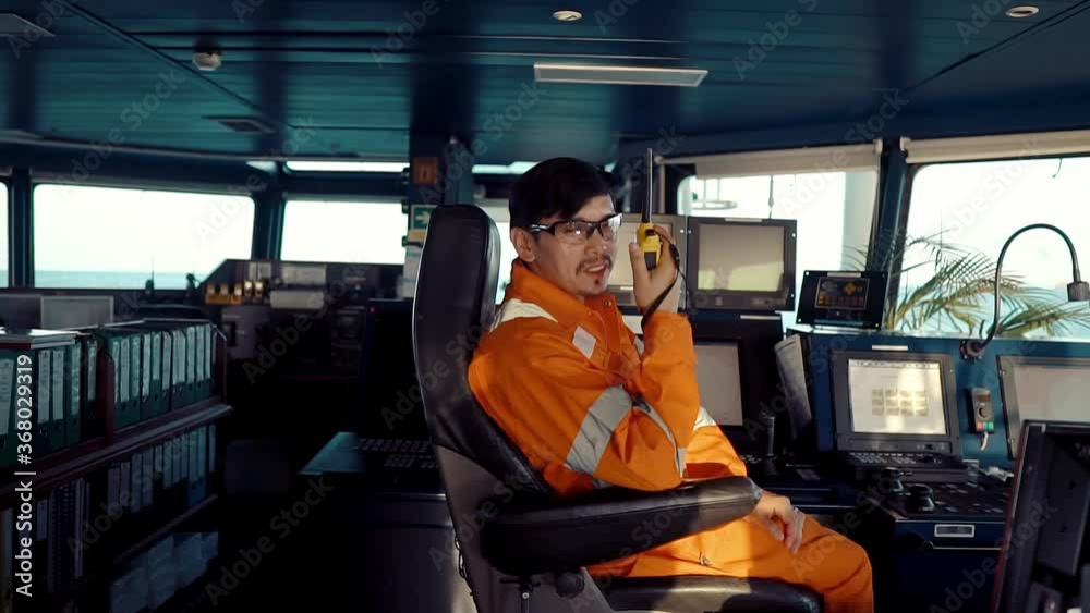 Filipino deck Officer on bridge of vessel or ship wearing coverall ...