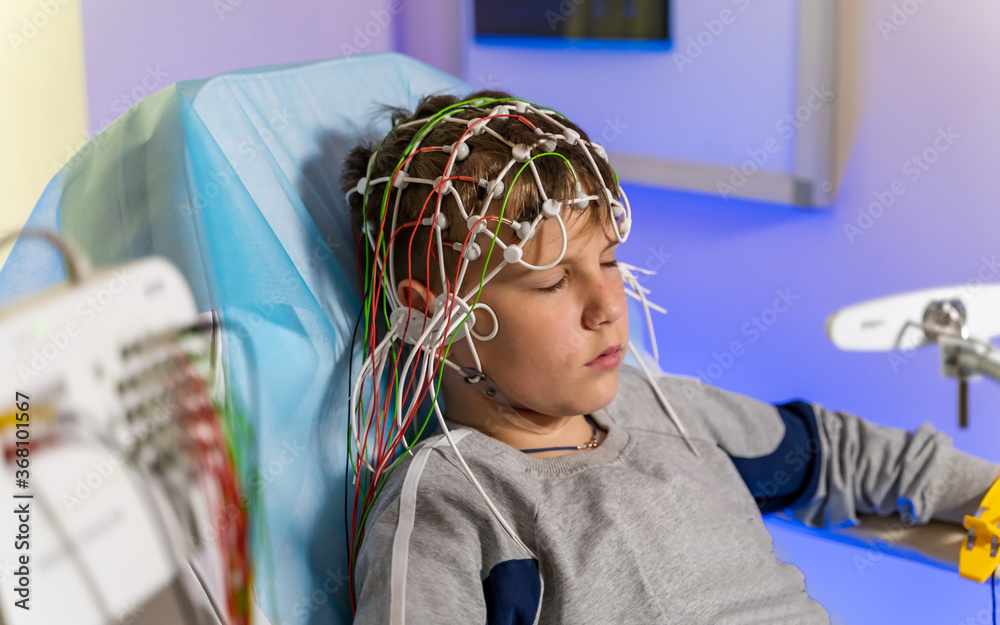 EEG electrode placement to patient during EEG record ...