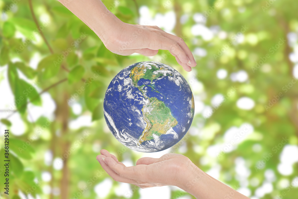 Save earth concept. Hands with Earth over green nature background ...