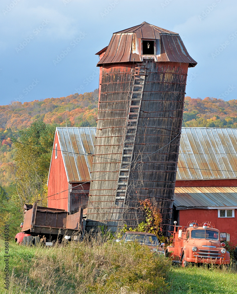 Amusing scene in rural Vermont with leaning silo, old weathered red ...