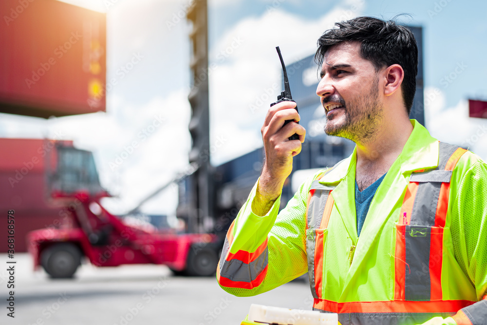 Confident Caucasian man engineer wearing yellow safety helmet using ...