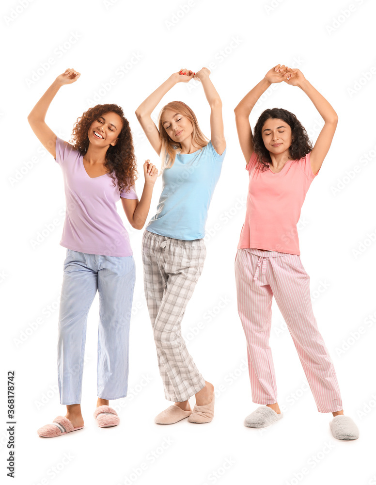 Beautiful young women in pajamas on white background Stock Photo ...