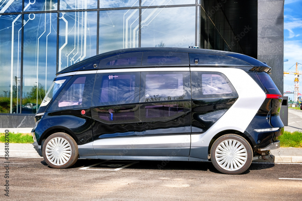 driverless electric self-driving vehicle by Kamaz against office ...