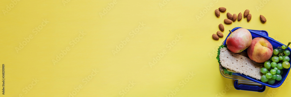 Large yellow background with school lunch with crispbreads with lettuce ...