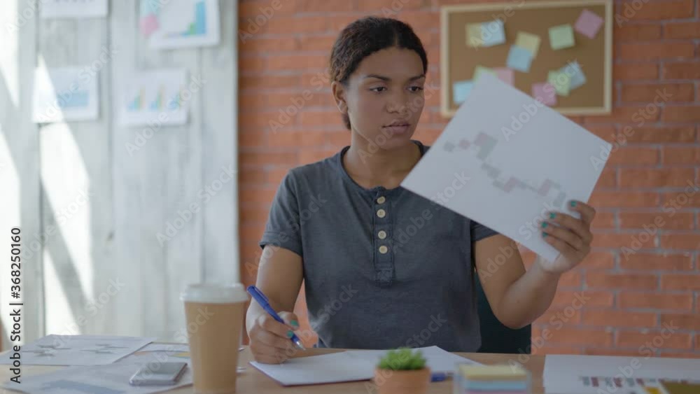 african american student girl doing homework in classroom. Girl works ...