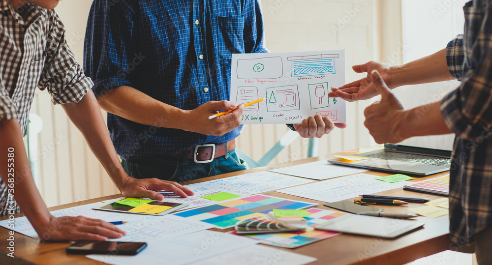 Website designers meeting to discuss and improve applications to meet ...