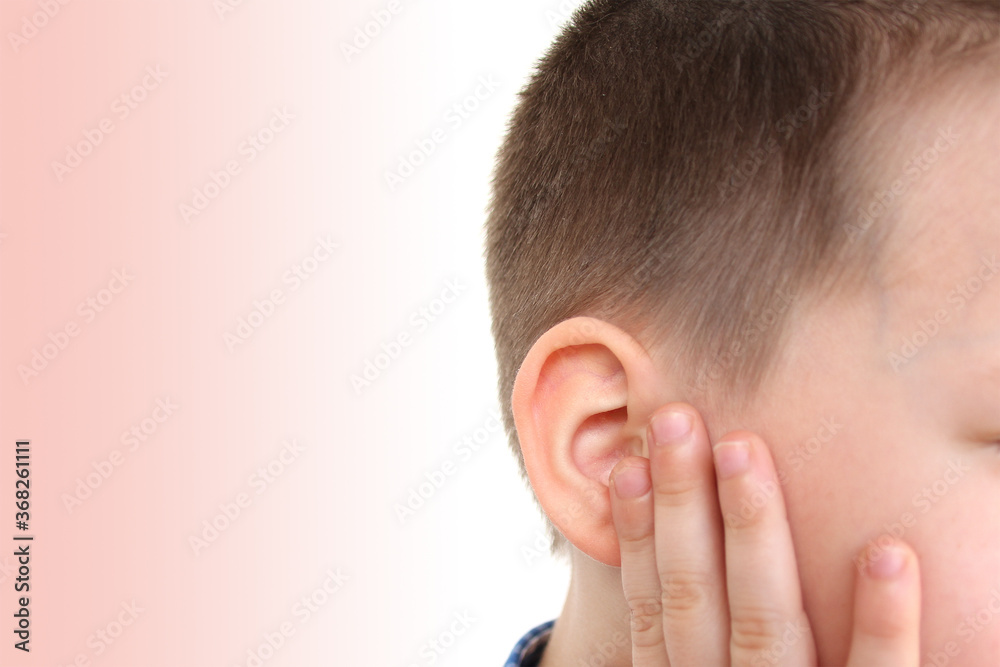 little boy holds on to the ear, part of the face close-up, medical ...
