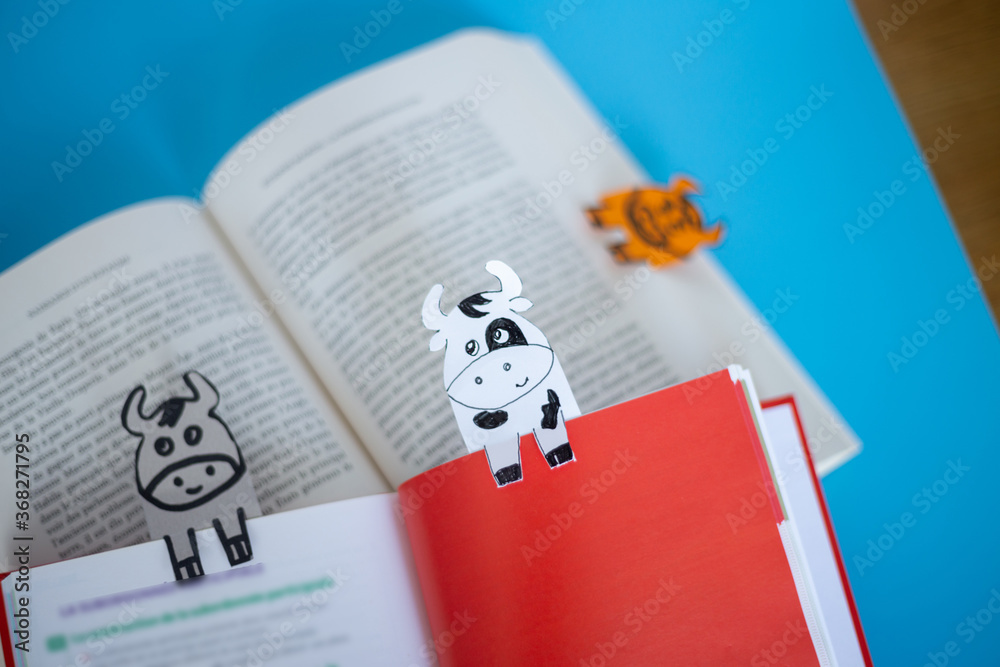 book with paper cow and bull bookmarks , soft focus, creative ideas for ...
