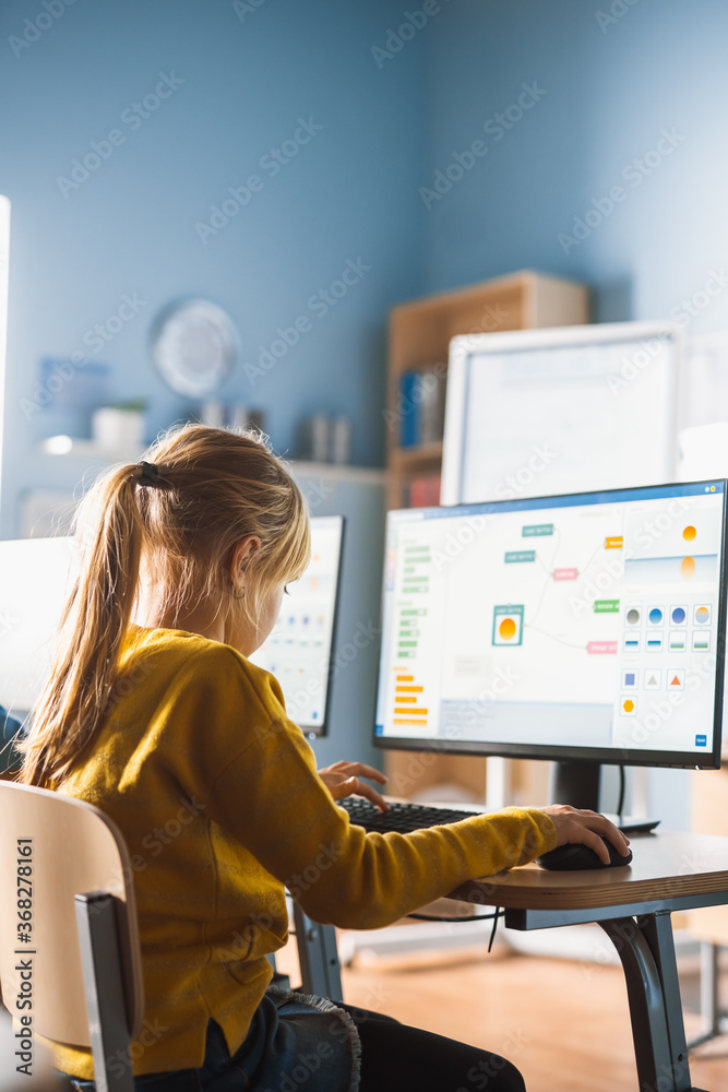 Elementary School Computer Science Classroom: Cute Little Girl Uses ...