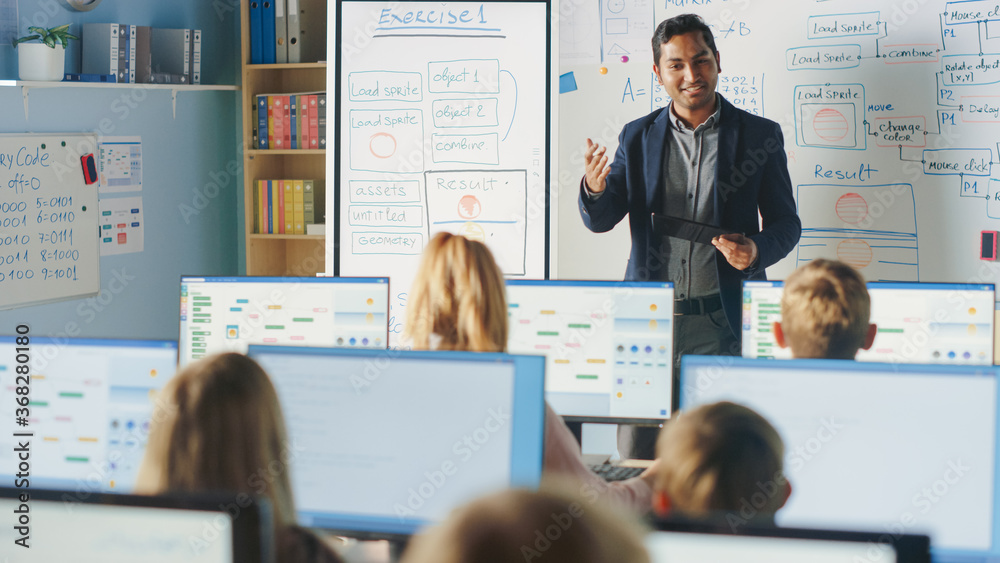 Elementary School Computer Science Class: Teacher Uses Digital Tablet ...