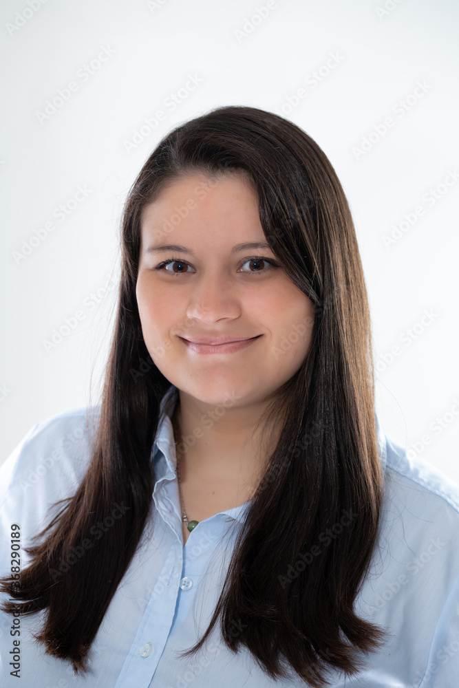Young professional lady poses for a studio headshot. She is caucasian ...