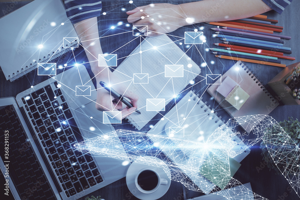 E-mail abstract envelop drawing over hands taking notes background ...