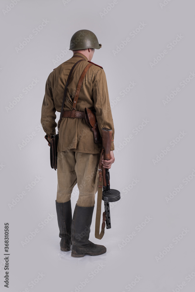 Male actor in the uniform of an officer and a helmet of the Soviet Army ...