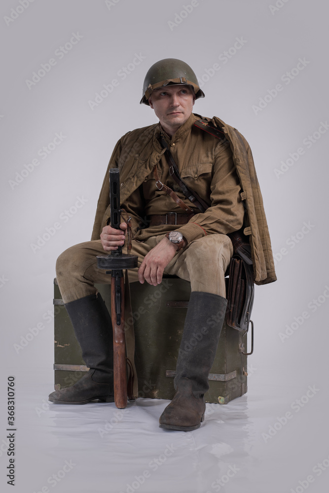 Male actor in the uniform of an officer and a helmet of the Soviet Army ...