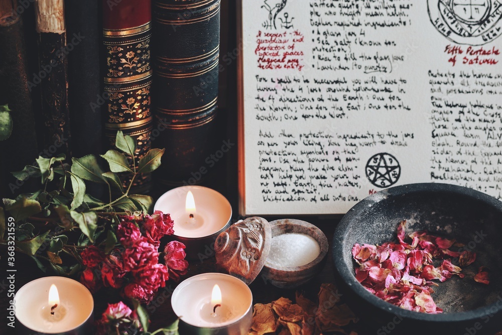 Wiccan witch altar with an open book of shadows with hand written spell ...
