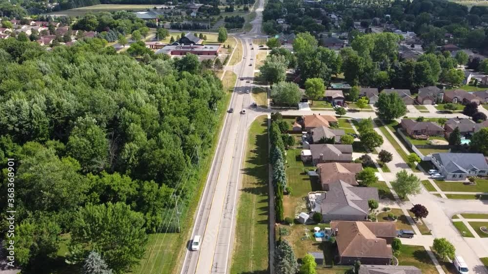 Dichotomy of suburbia and a forest shown in this tracking shot over a ...