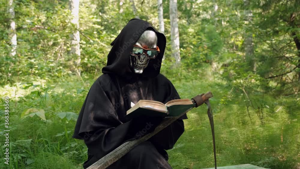 Grim Reaper Reading a Book while Sitting on a Bench in a City Park ...