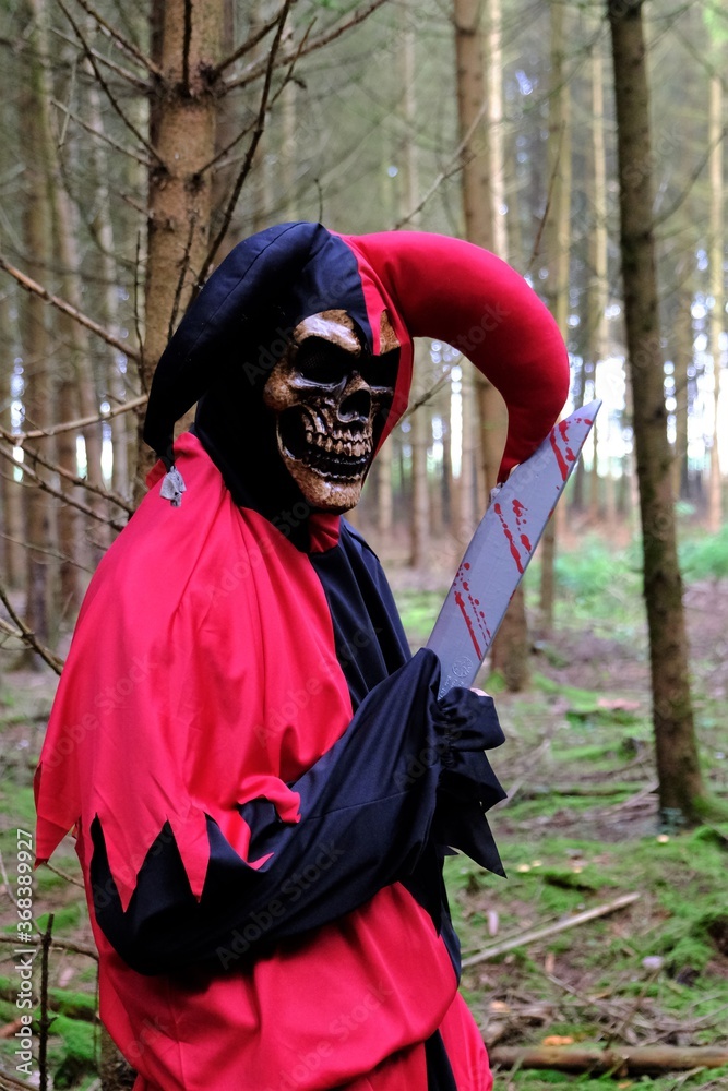 Evil Jester halloween costume.Halloween. Evil harlequin with a bloody ...
