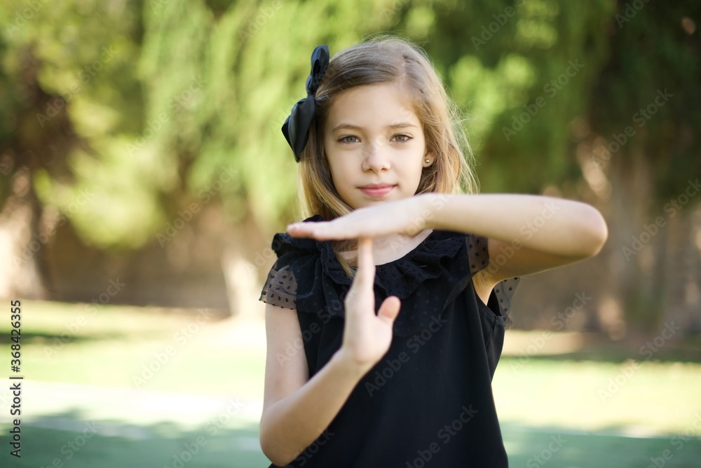 Young pretty blonde girl tired and bored, making a timeout gesture ...