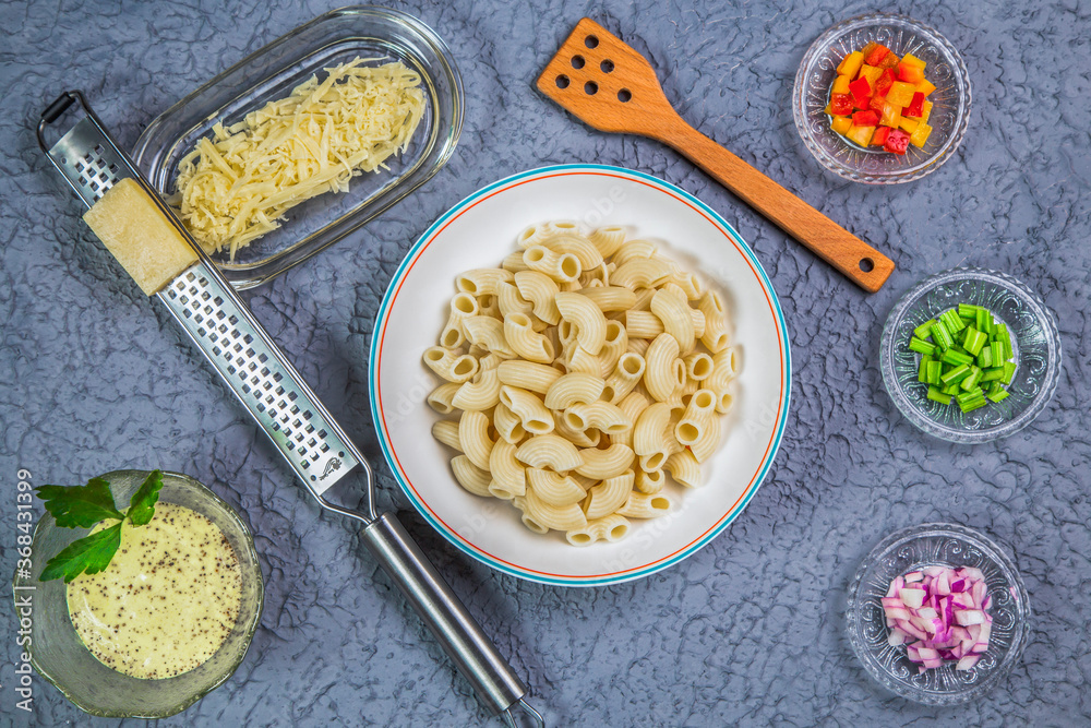Top view of table with pasta and cheese. Table with boiled maccheroni ...
