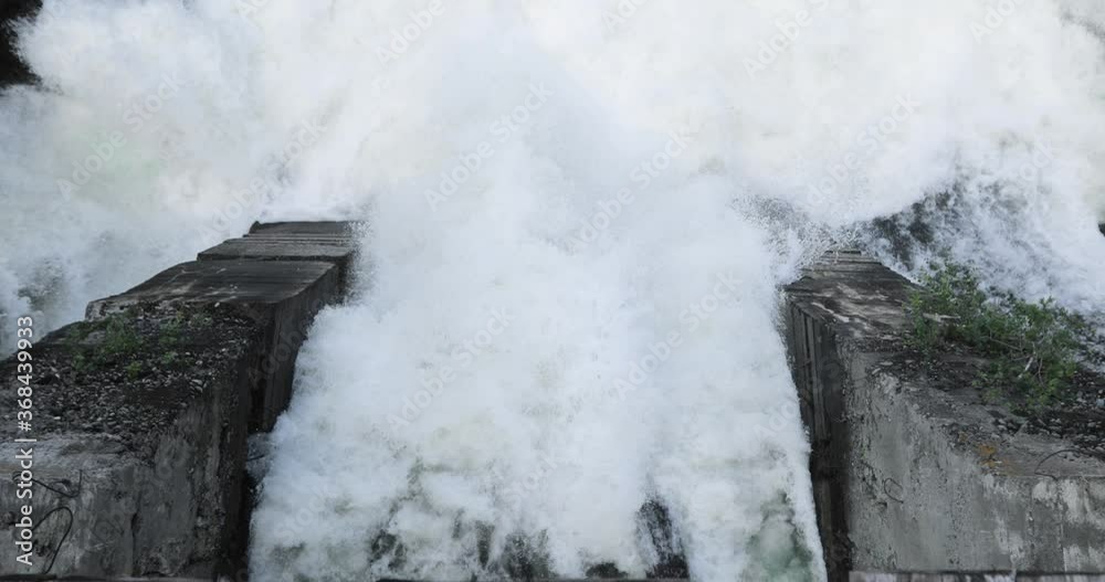 Waterfalls and streaming current on damaged hydroelectric power station ...