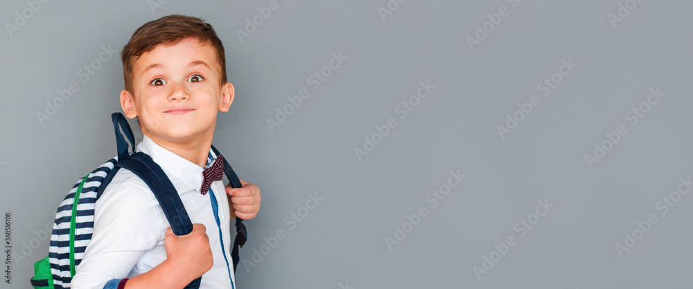 European cute boy leaving or going to school with small school bag ...