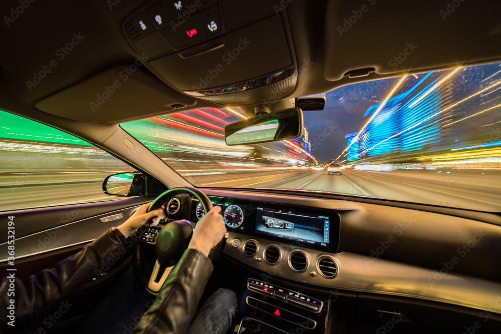 Movement of the car at night at high speed view from the interior with ...