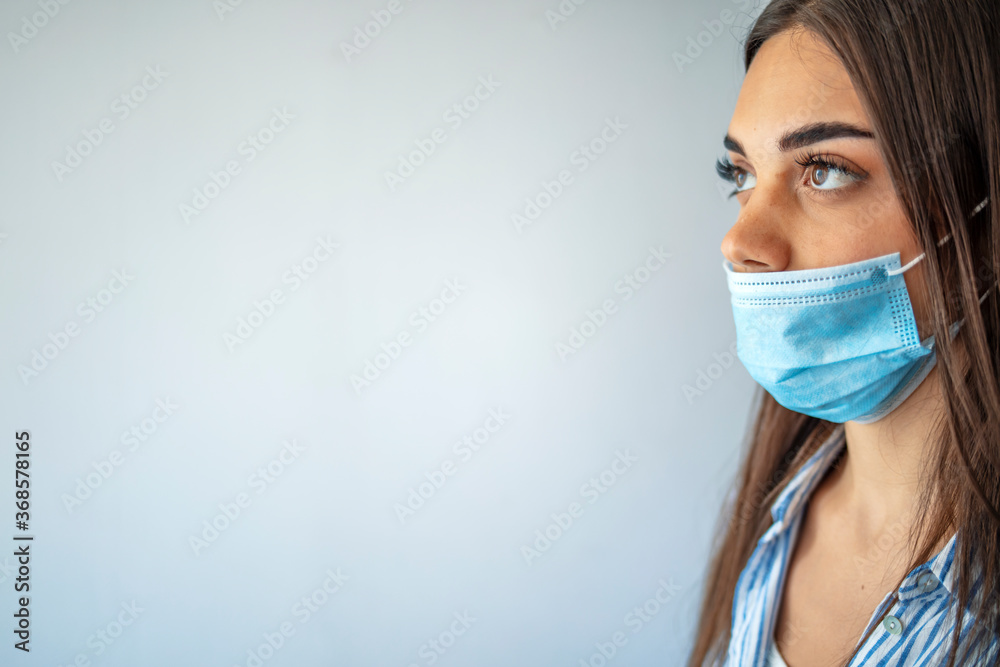 Young woman demonstrates the wrong way to wear a mask to avoid the ...