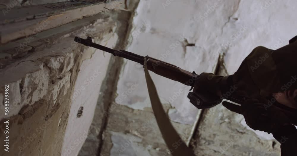 A special forces soldier fires an automatic assault weapon. Masked team ...