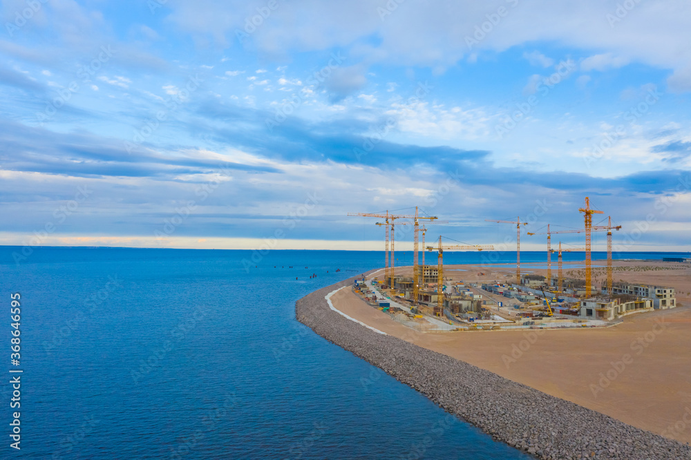 Construction site on the seashore. Concept - erection of buildings in ...