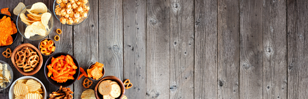 Assorted salty snacks. Corner border with copy space. Top down view on ...