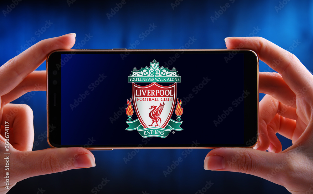 Hand holding smartphone displaying logo of Liverpool FC Stock Photo ...