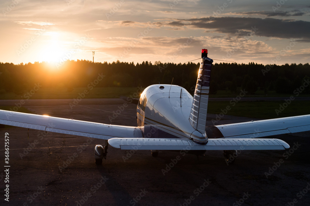 Quadruple aircraft parked at a private airfield. Rear view of a plane ...