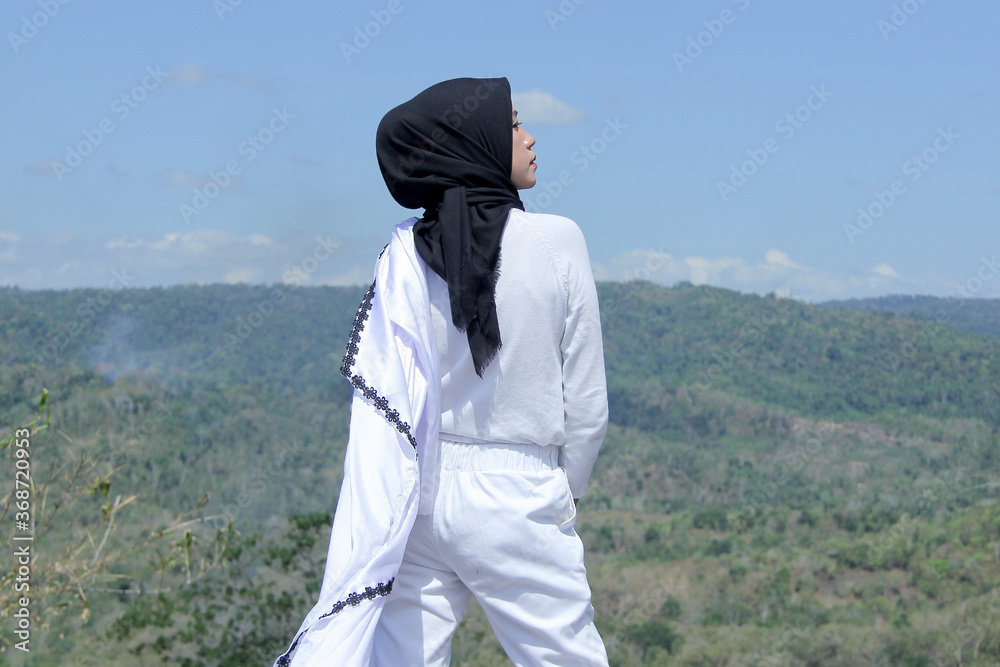 beautiful woman wearing black and white outfit in summer. look sideways ...