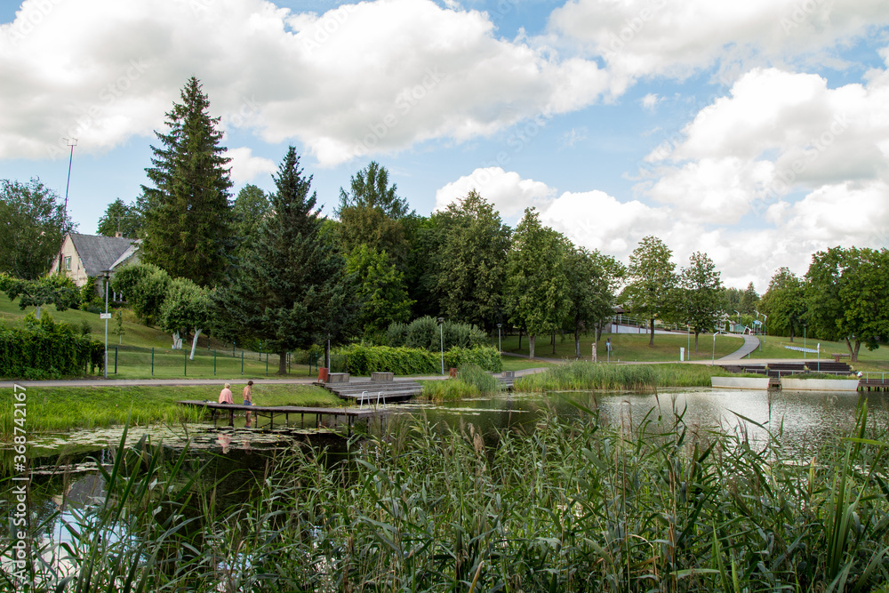 Park and walking paths in Moletai. Lakeside paths. Park benches ...