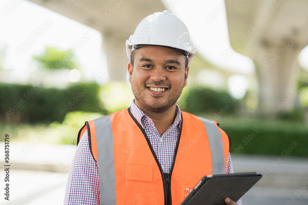 Asian civil engineer operate with tablet to control working at ...