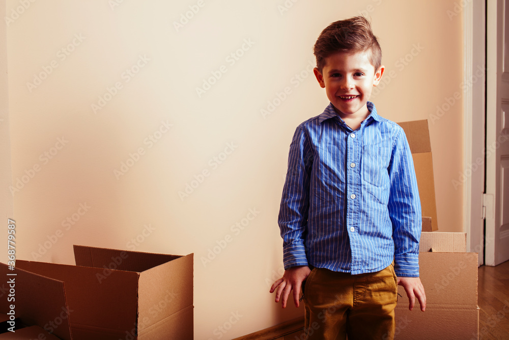 little cute boy in empty room, move to new house. home alone among ...